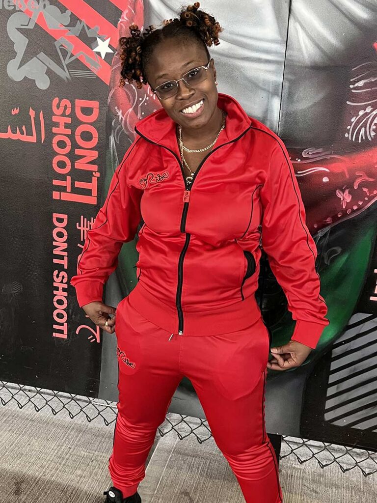 Woman’s Dripping Red tracksuit, black piping with custom rubber logo ...